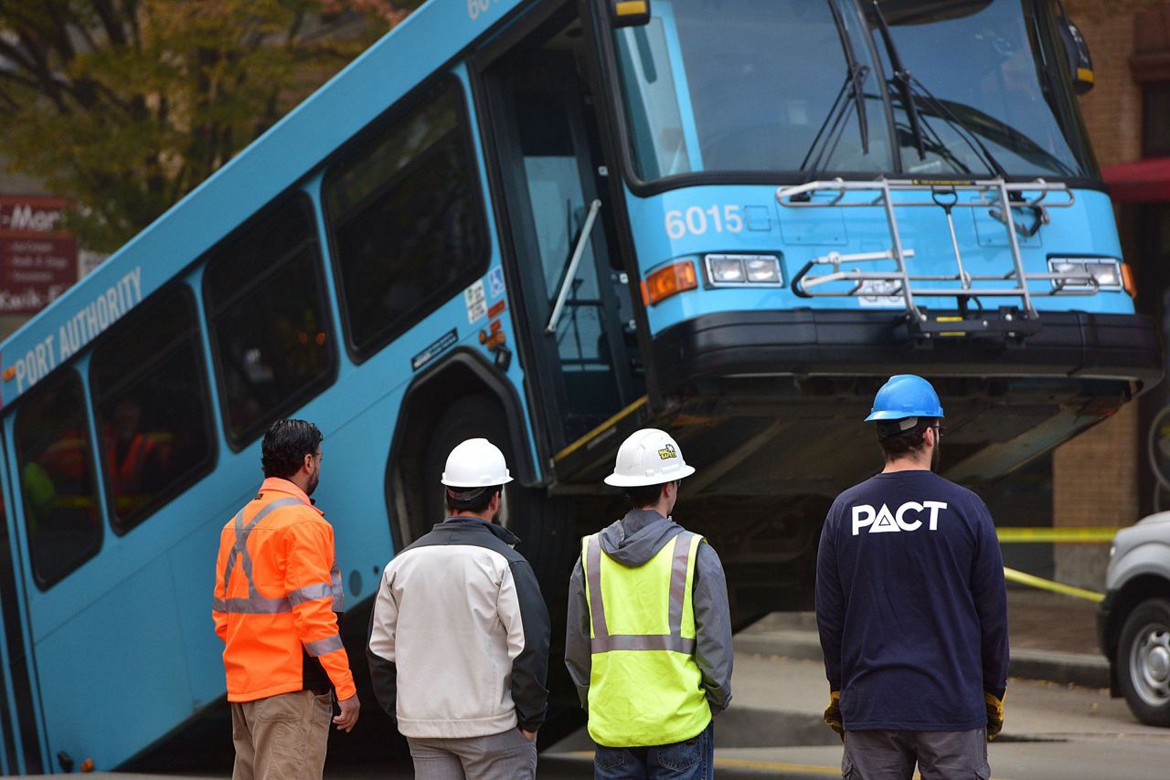 Sinkhole opens, swallows part of city bus during rush hour