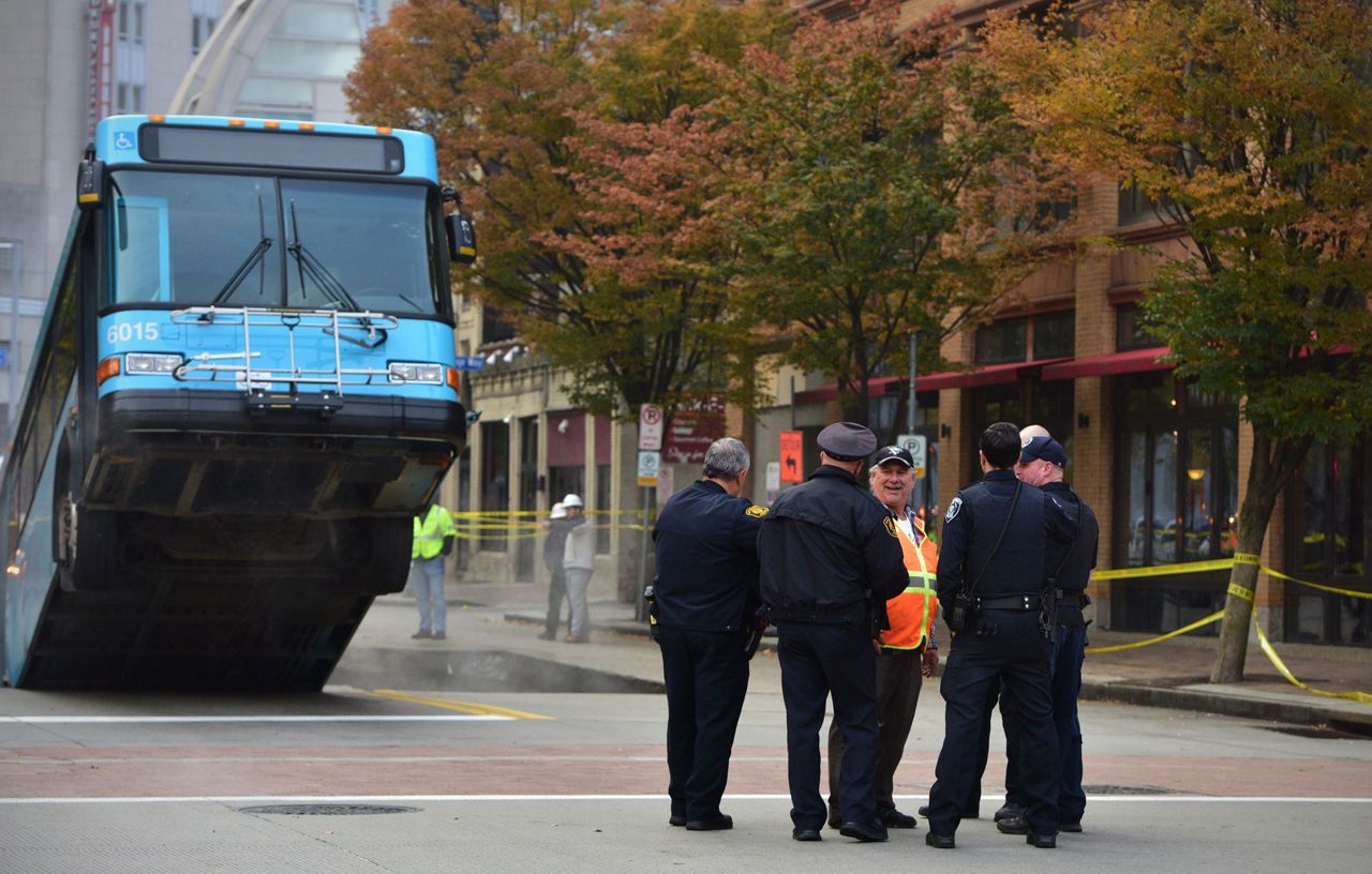 Sinkhole opens, swallows part of city bus during rush hour