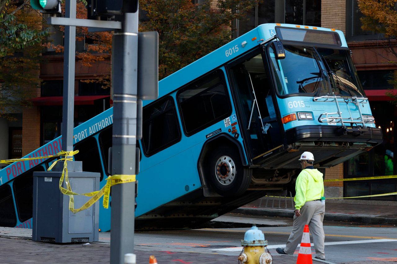 Sinkhole opens, swallows part of city bus during rush hour