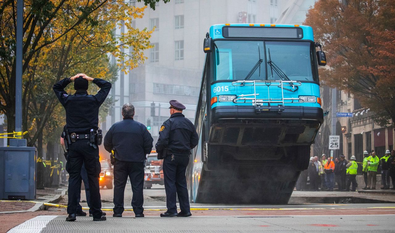 Sinkhole opens, swallows part of city bus during rush hour