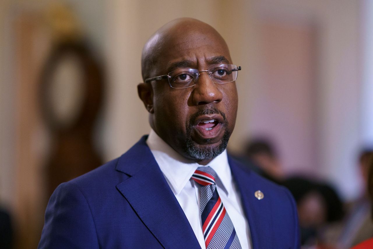 Warnock balances partisanship with broad pitch ahead of 2022