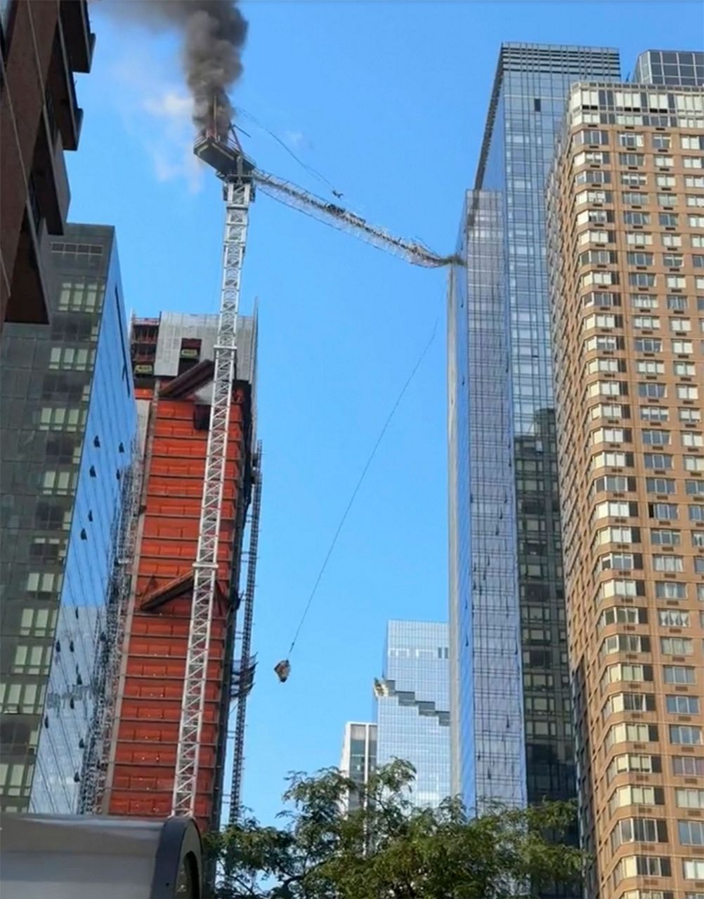 Construction crane catches fire in New York City and hits building as ...