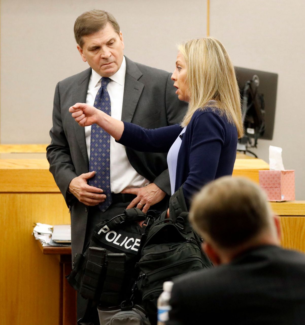 The Latest: Officer cries recalling night she shot neighbor