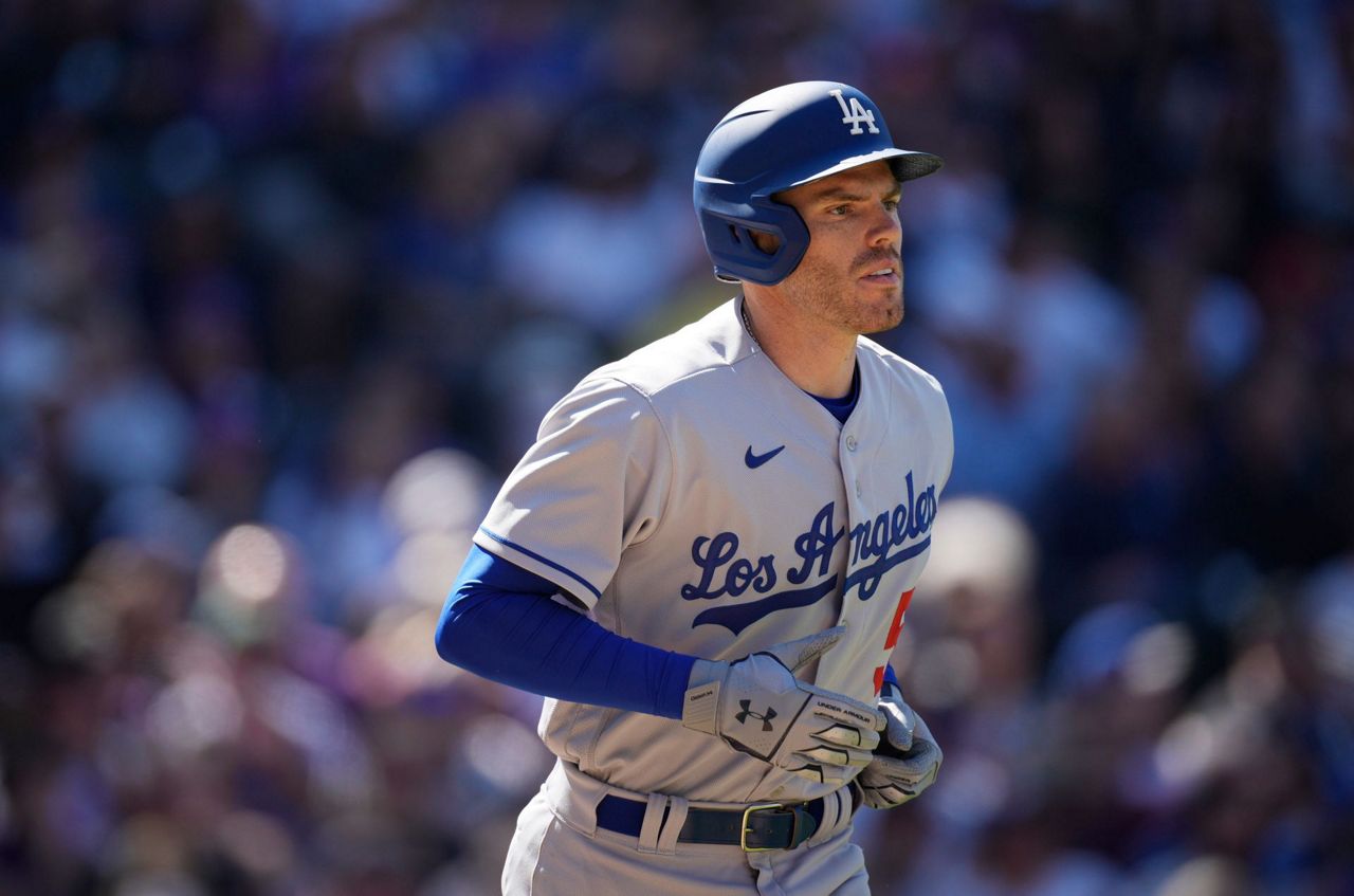 Freeman reaches 3 times, scores in Dodgers debut, beats Rox