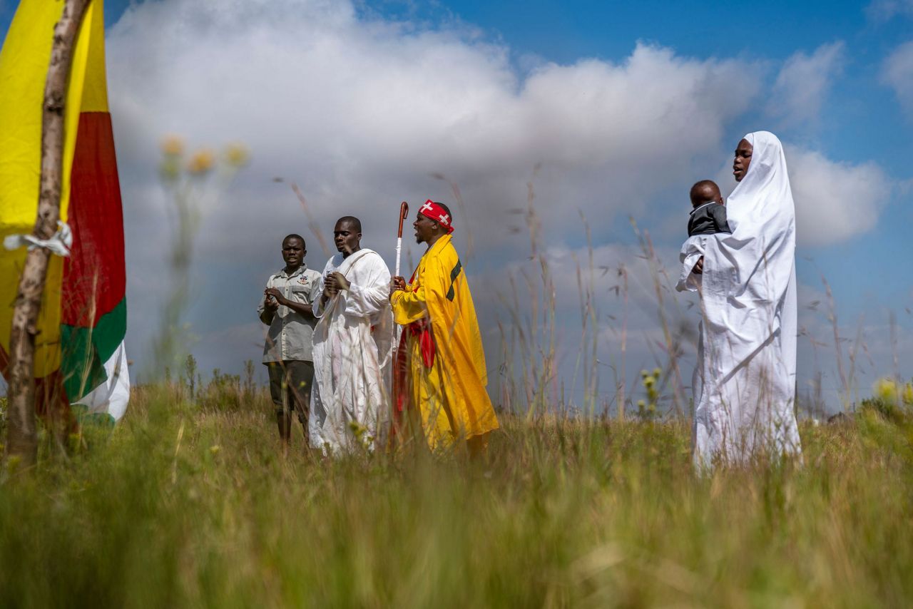 Singing hymns through masks, Christians mark pandemic Easter