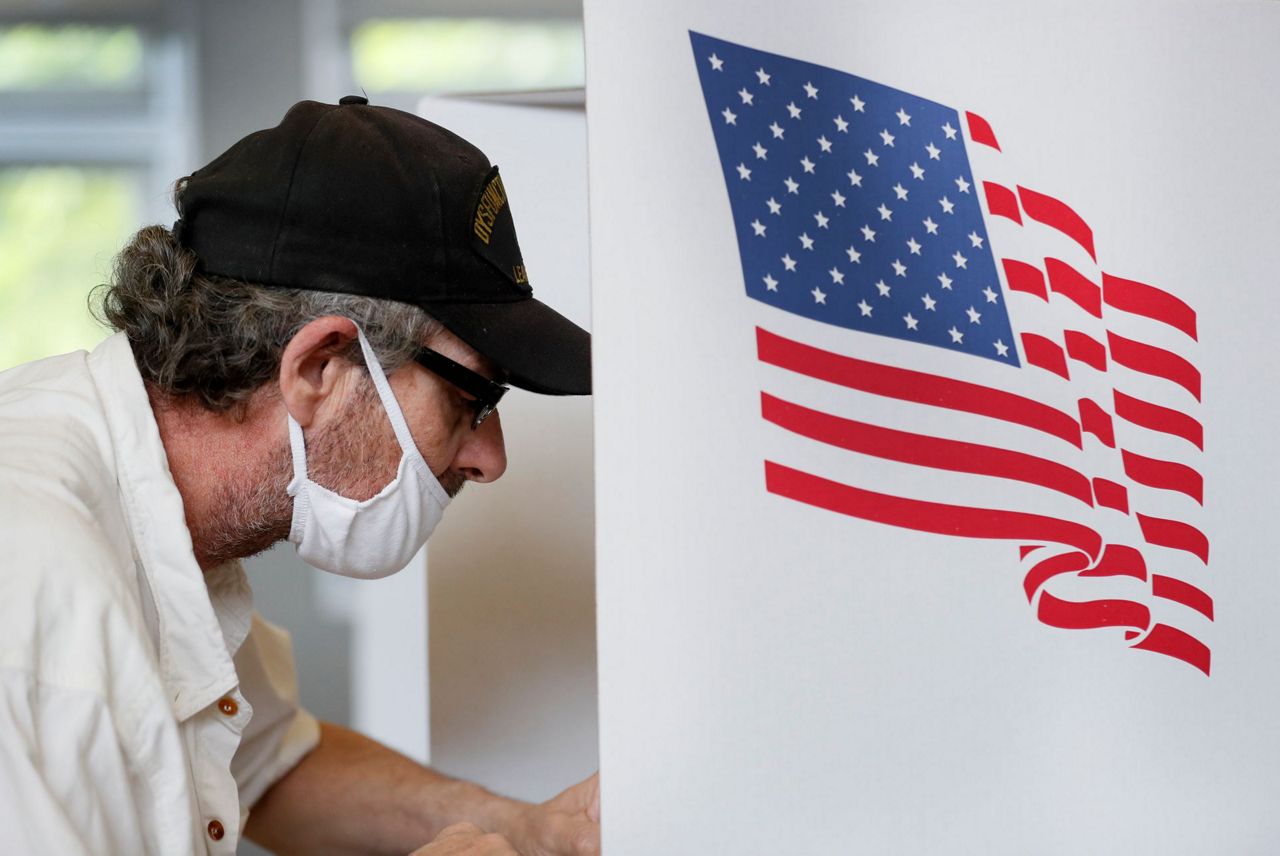 Iowa primary voters deciding King's fate, Ernst's challenger