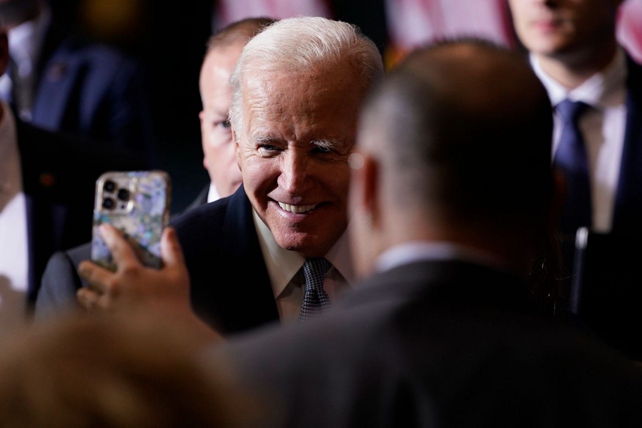 One hug and one selfie at a time, Biden's mission to connect