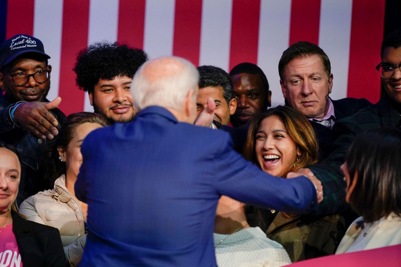 One hug and one selfie at a time, Biden's mission to connect