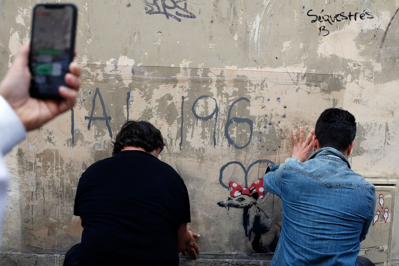 Street artist Banksy splashes Paris with works on migrants