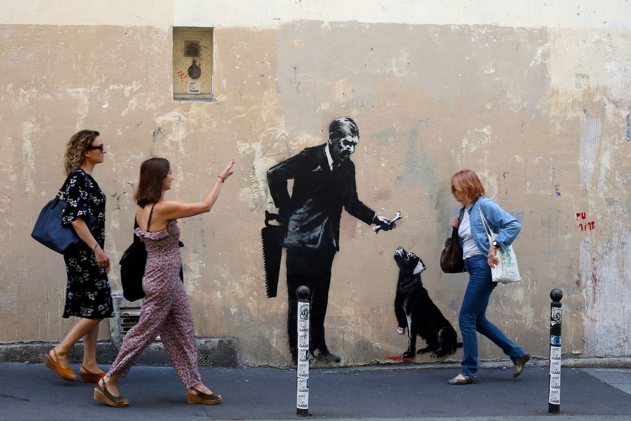 Street artist Banksy splashes Paris with works on migrants
