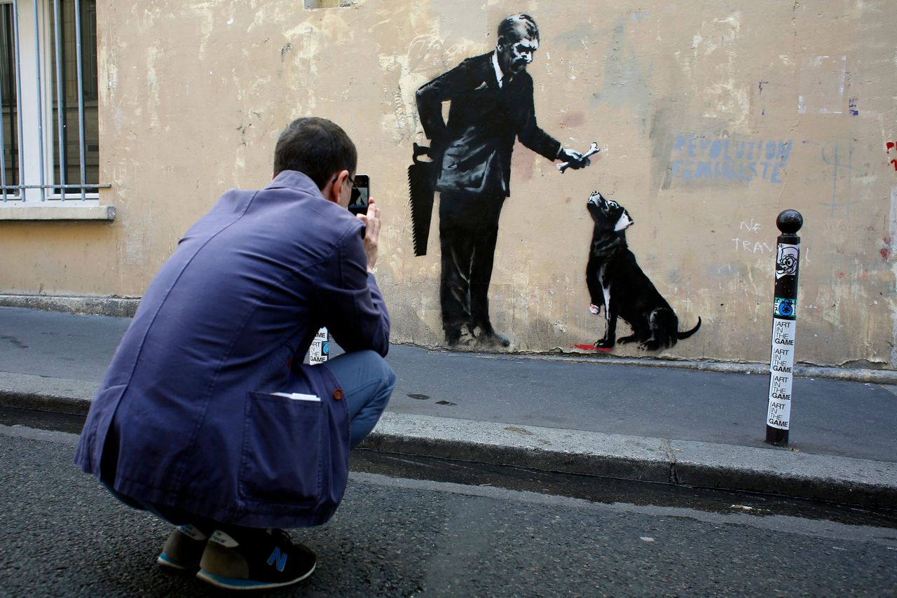 Street artist Banksy splashes Paris with works on migrants