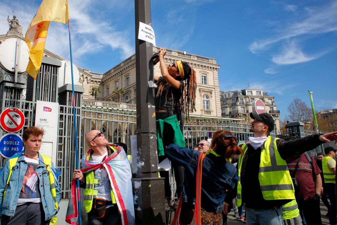 France's yellow vest protesters march despite bans, injuries
