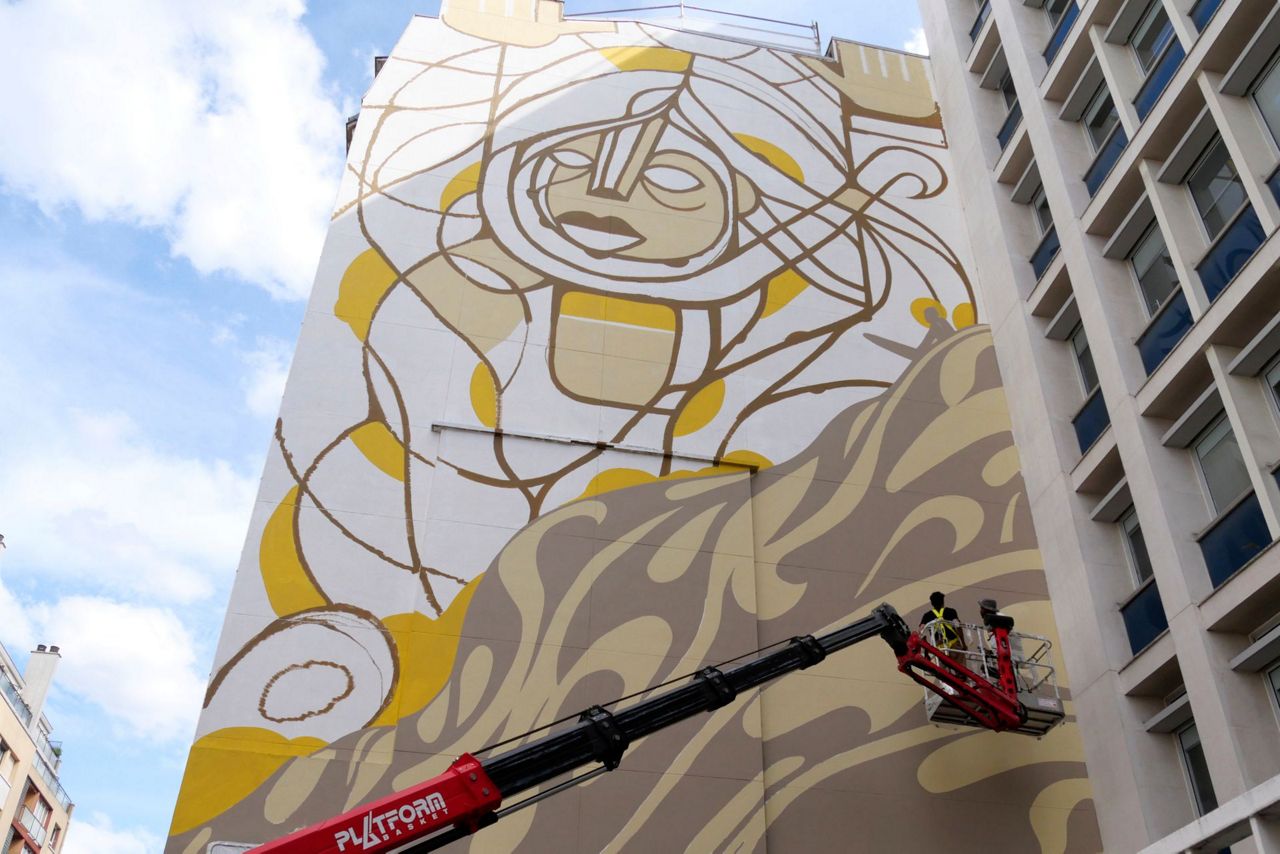 American, French artists revive hope on giant Paris mural