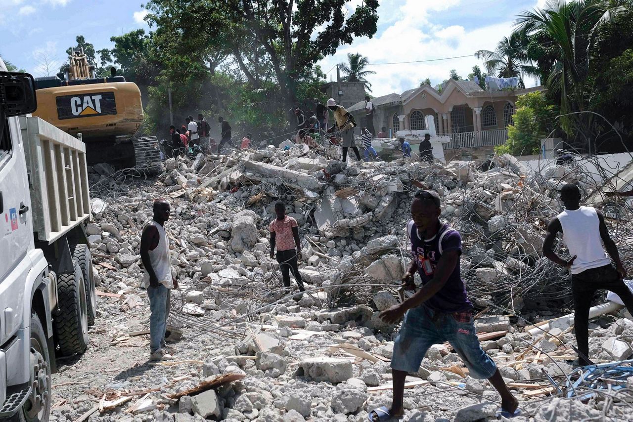 Quake injured wait for help as new disaster overwhelms Haiti