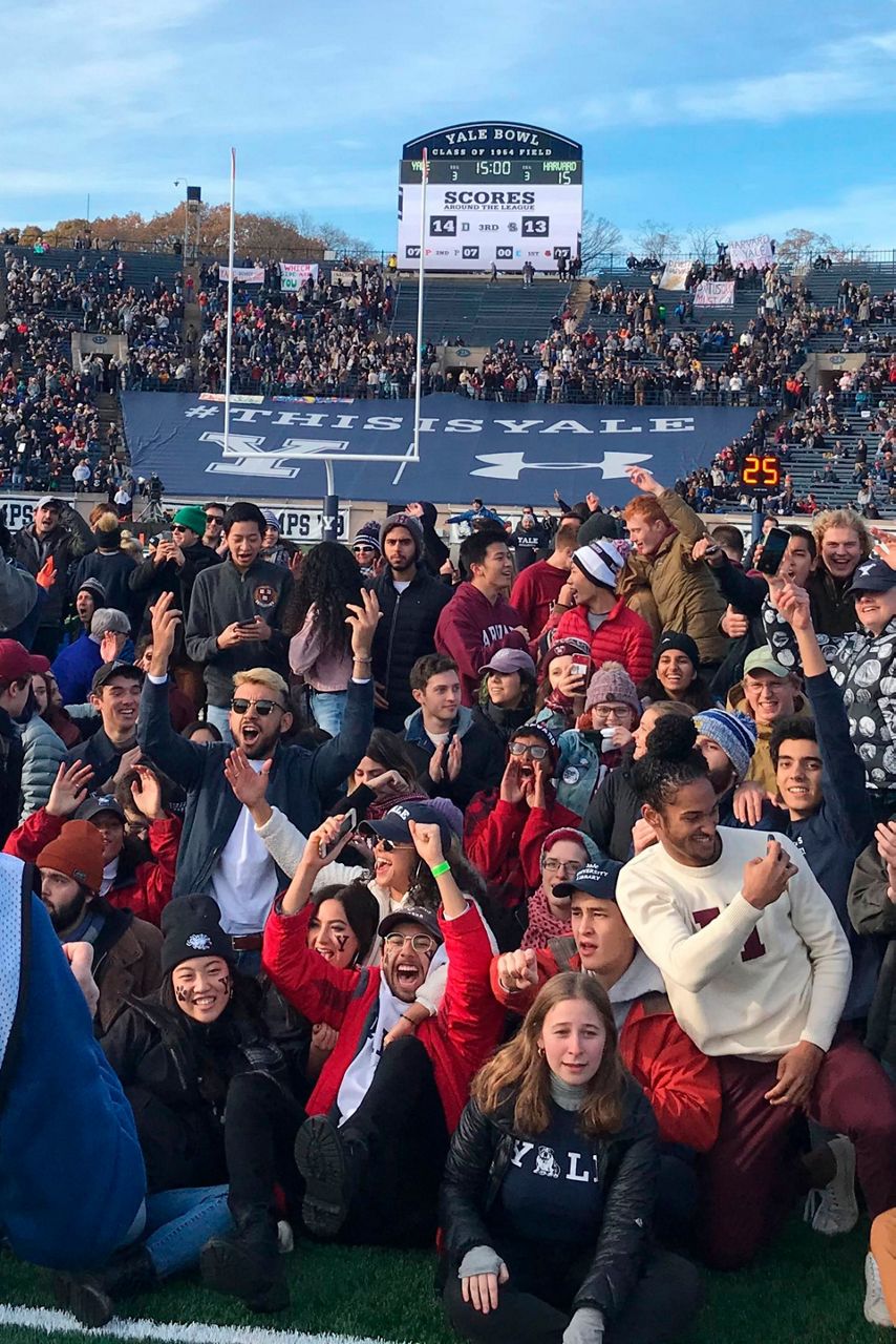Students storm field at halftime of Harvard-Yale to protest