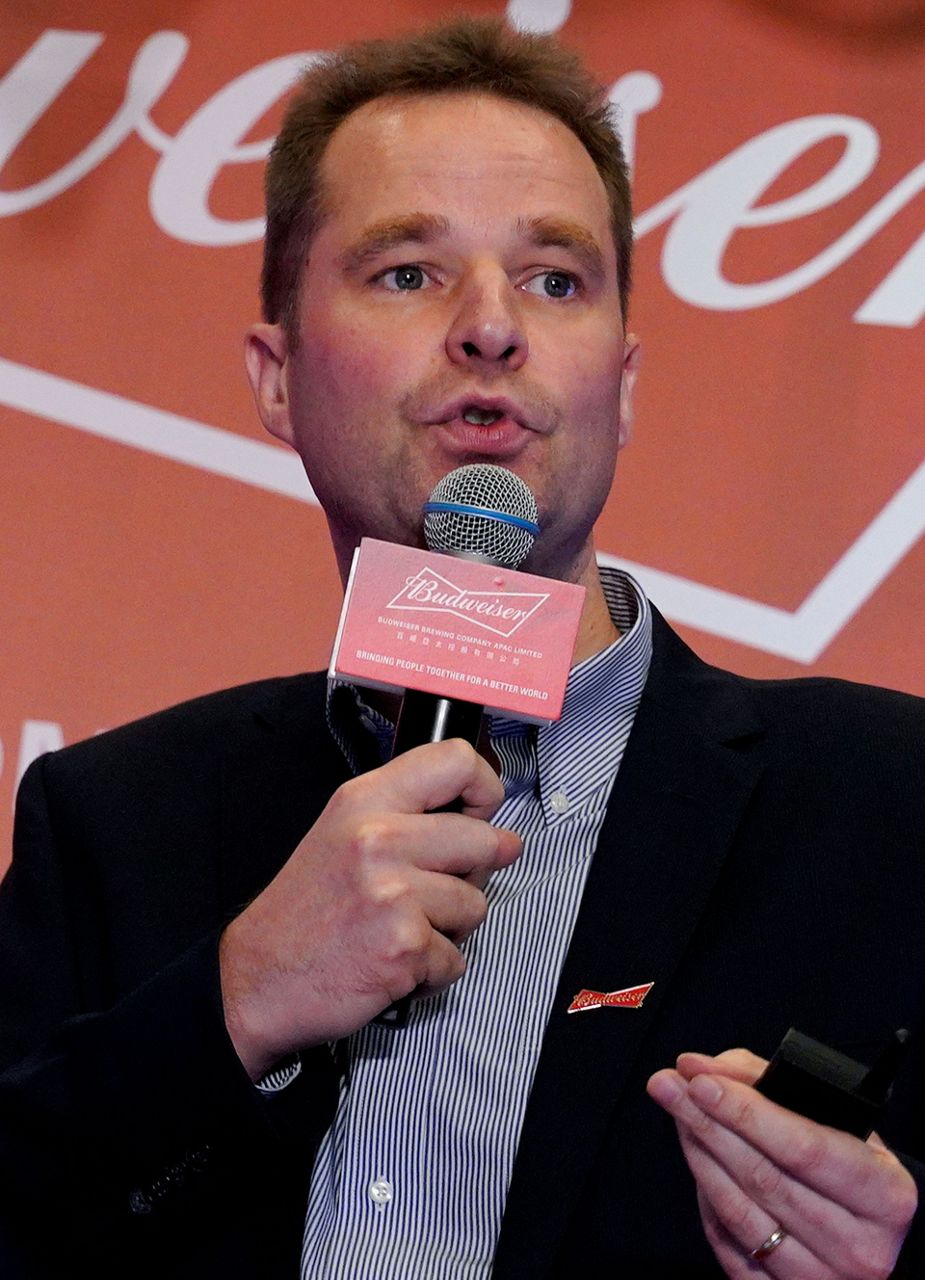 World's top brewer revives listing plans, halves IPO size