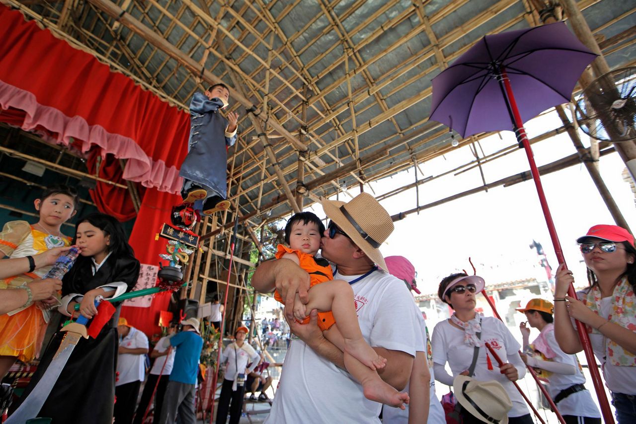 AP PHOTOS: Thousands join Hong Kong bun-snatching festival