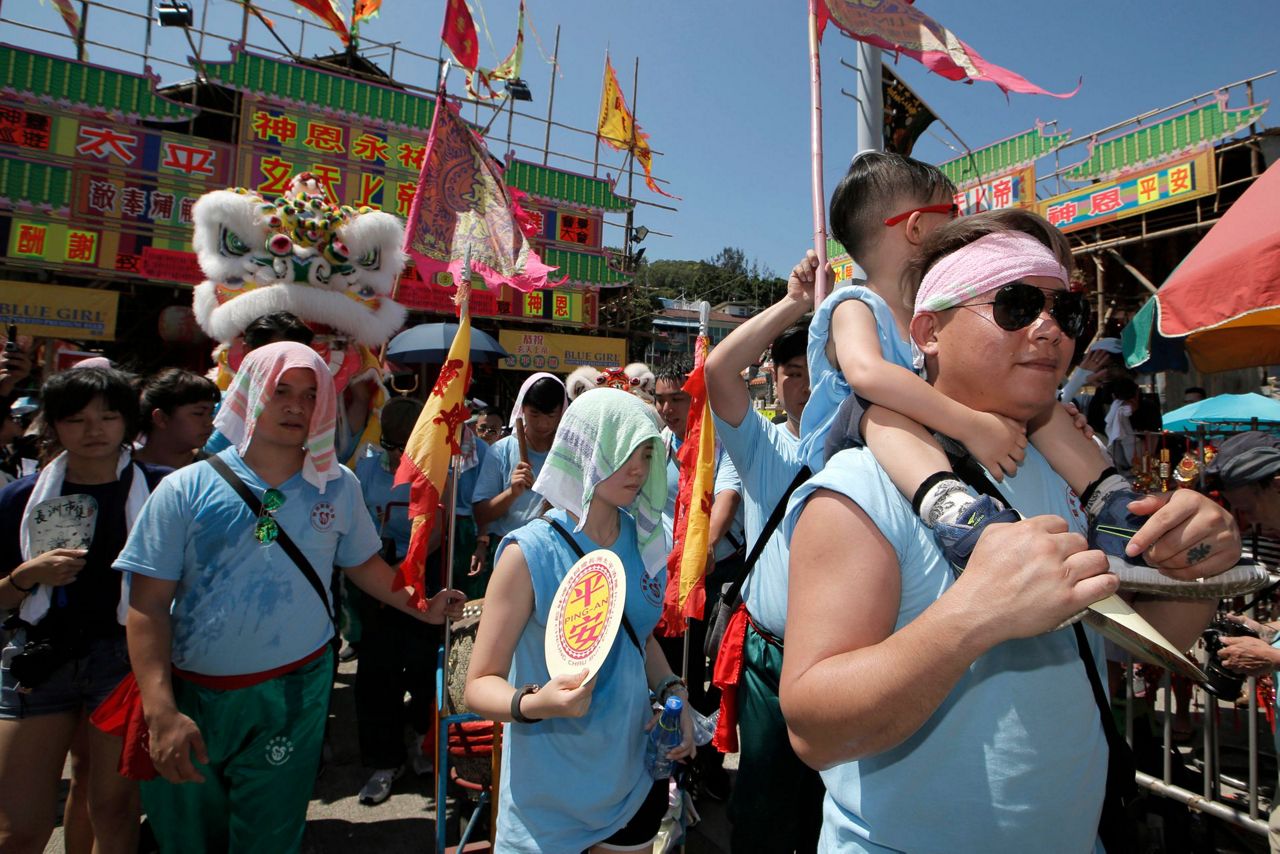 AP PHOTOS: Thousands join Hong Kong bun-snatching festival