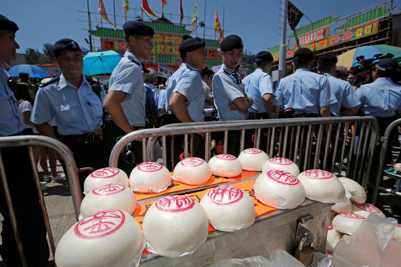 AP PHOTOS: Thousands join Hong Kong bun-snatching festival
