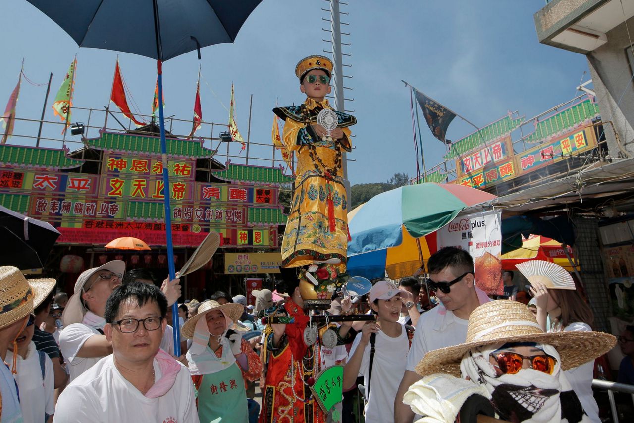 AP PHOTOS: Thousands join Hong Kong bun-snatching festival