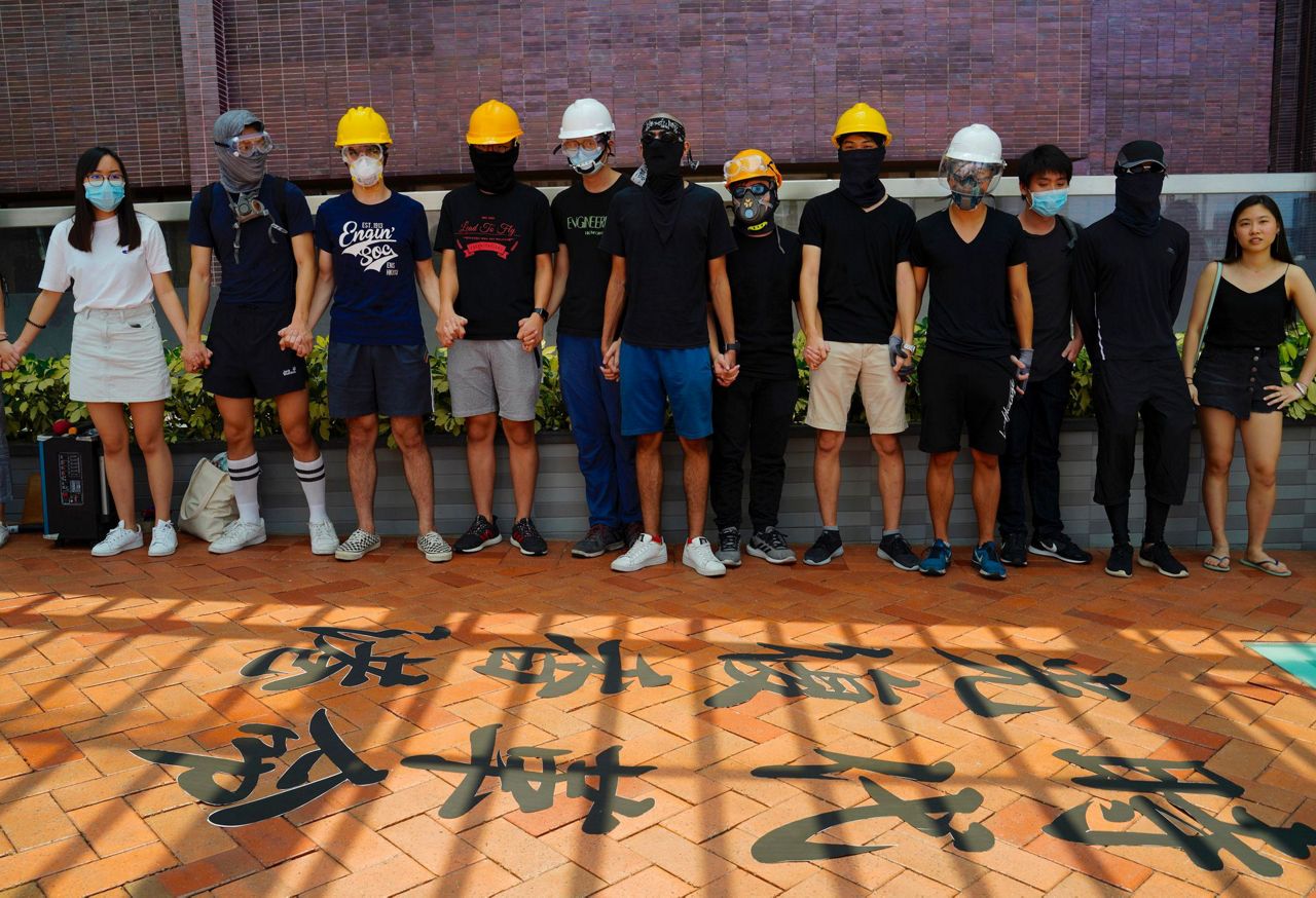 Hong Kong tells US to stay out, students form protest chains