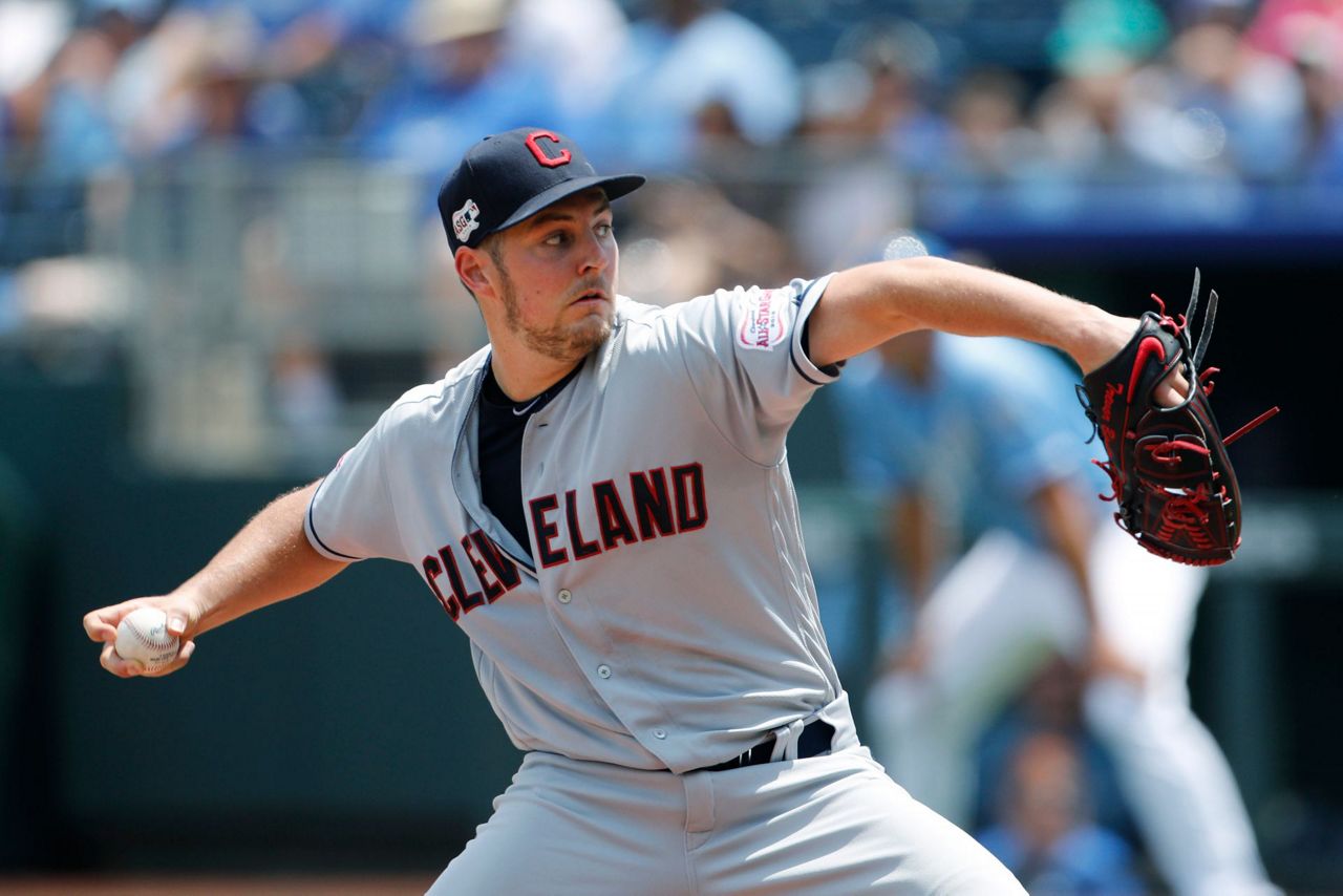 Long toss: Indians pitcher Bauer heaves ball over CF wall