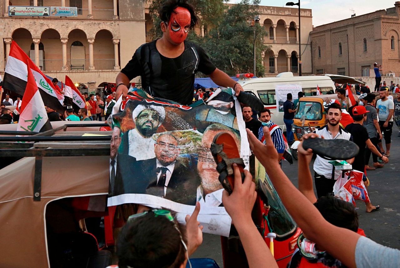 Officials: Protesters hang gunman in Baghdad square