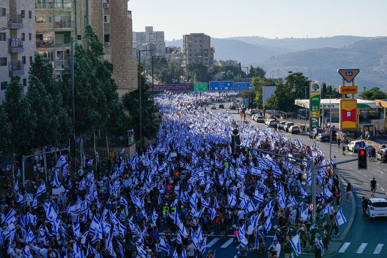 Hundreds of thousands march in Israel. Former security chiefs beg ...