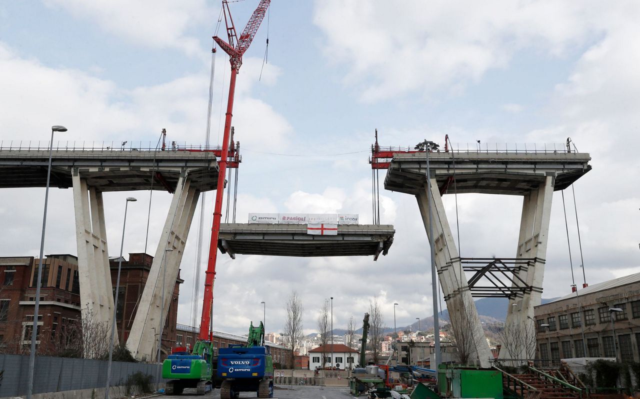 Workers carefully remove remains of collapsed Genoa bridge