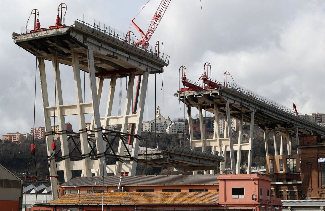 Workers carefully remove remains of collapsed Genoa bridge
