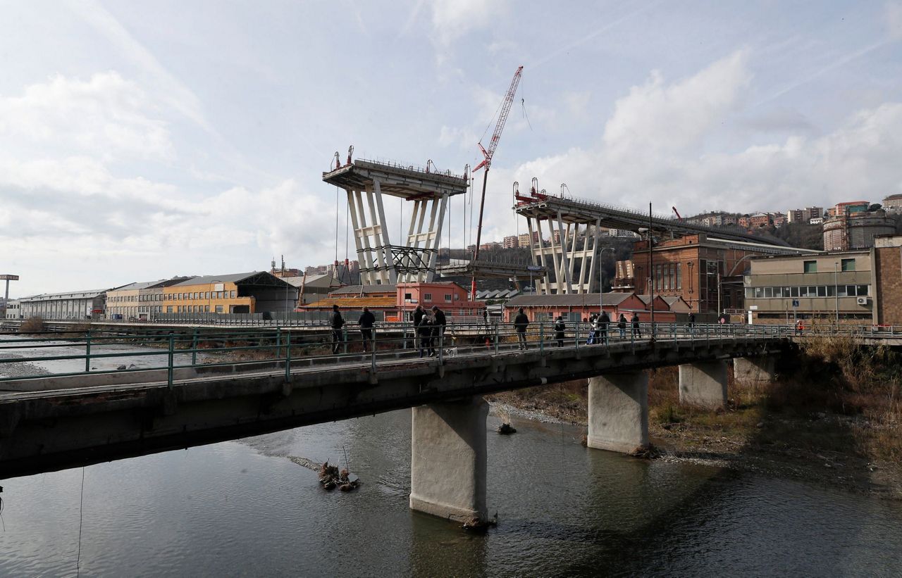 Workers carefully remove remains of collapsed Genoa bridge