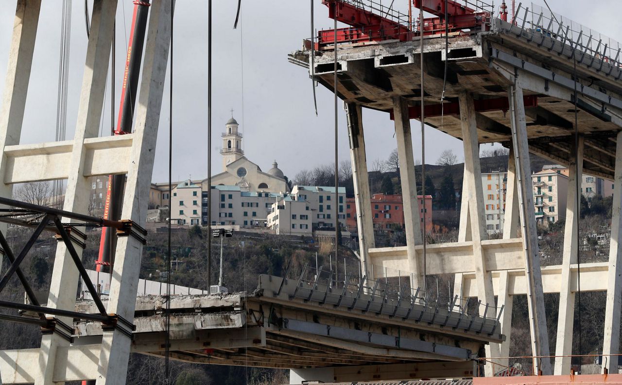 Workers carefully remove remains of collapsed Genoa bridge