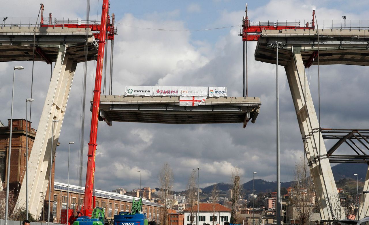 Workers carefully remove remains of collapsed Genoa bridge