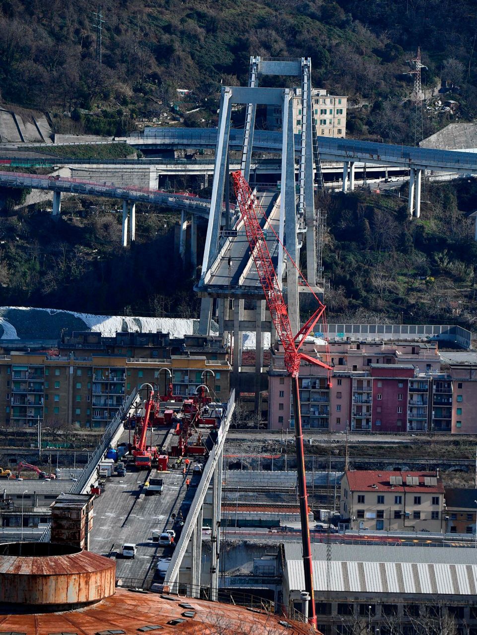 Workers carefully remove remains of collapsed Genoa bridge
