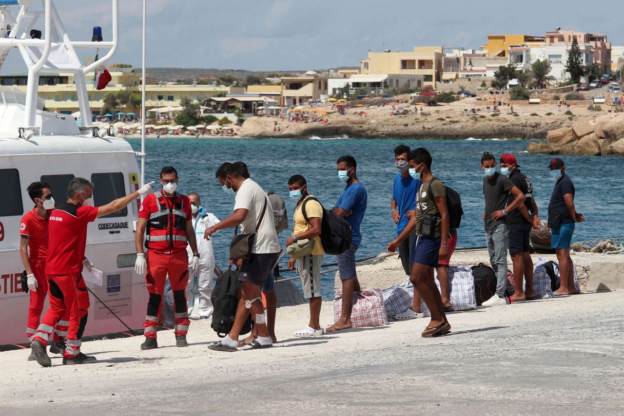 Migrants are moved from overcrowded Italian island facility