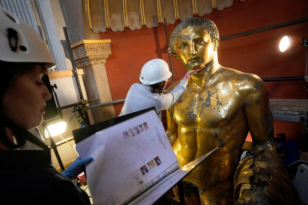 Vatican experts uncovering gilded glory of Hercules statue struck by ...