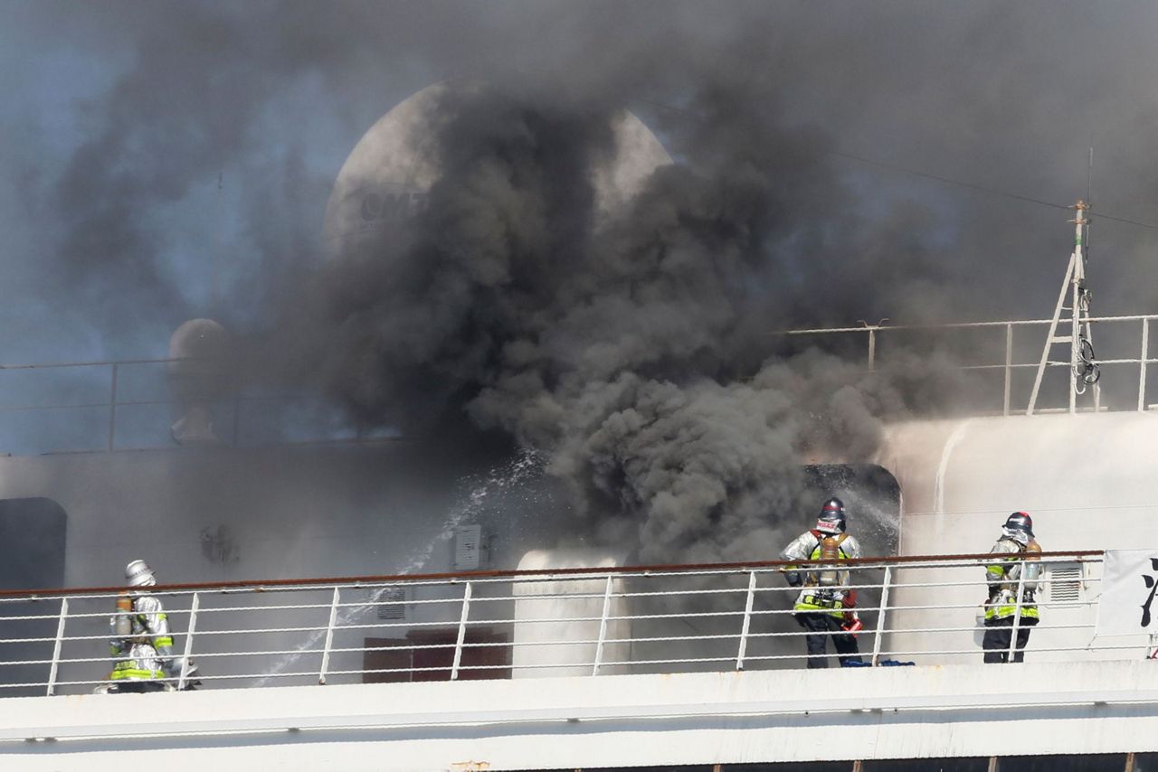 Black smoke billowing from cruise ship docked near Tokyo
