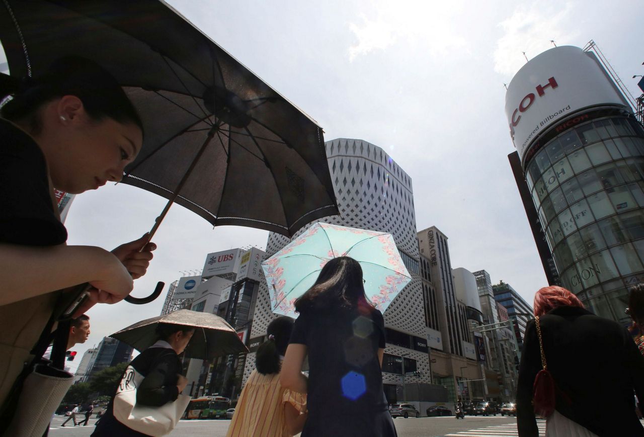 The Latest: Japan records its highest temperature ever