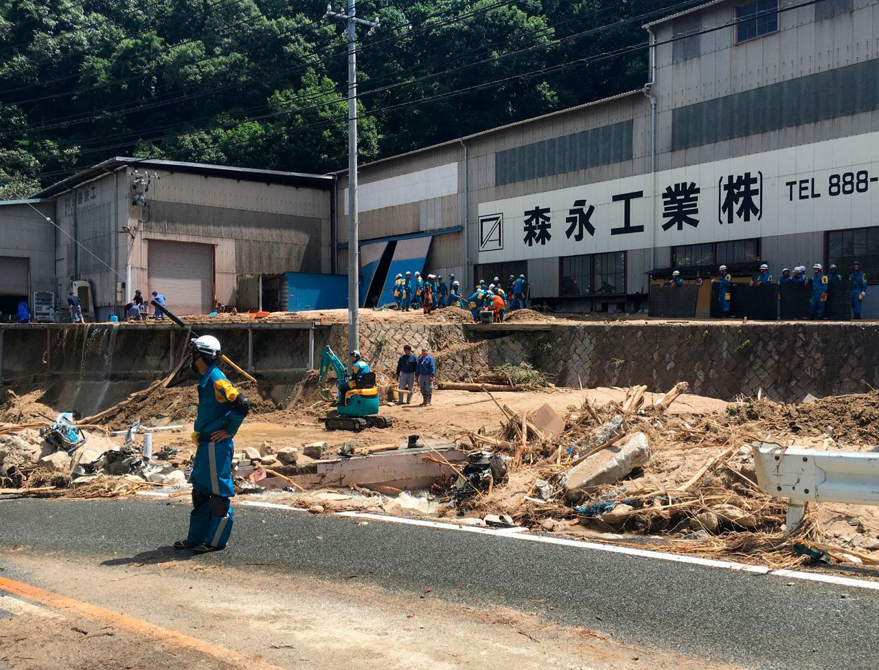 Rescuers look through mud for Japan flood victims; 122 dead