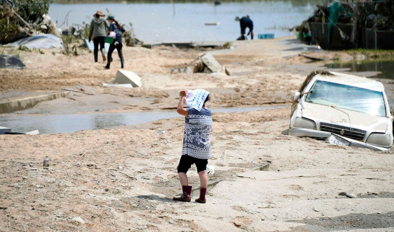 Rescuers look through mud for Japan flood victims; 122 dead
