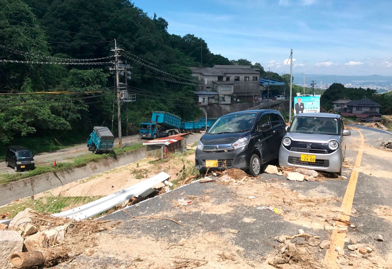 Rescuers look through mud for Japan flood victims; 122 dead