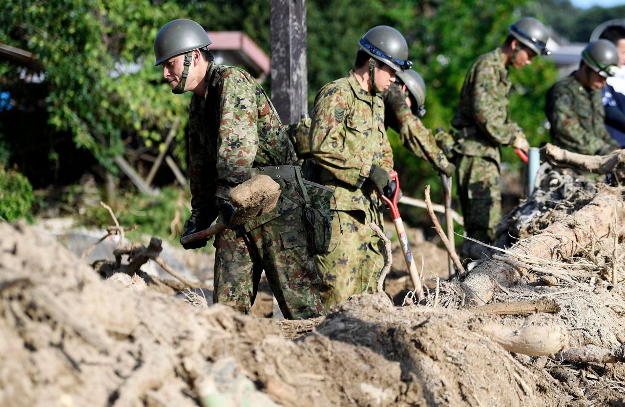 Rescuers look through mud for Japan flood victims; 122 dead