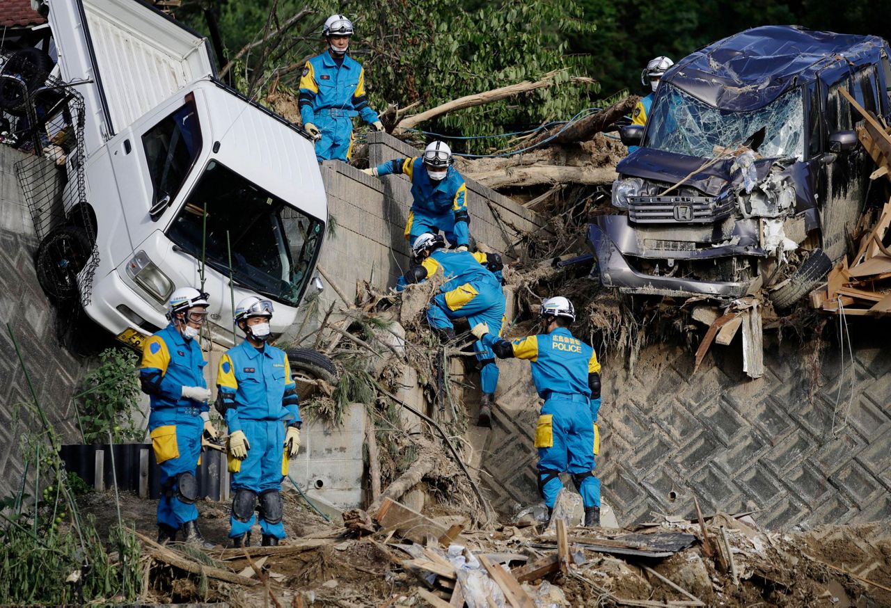 Rescuers look through mud for Japan flood victims; 122 dead