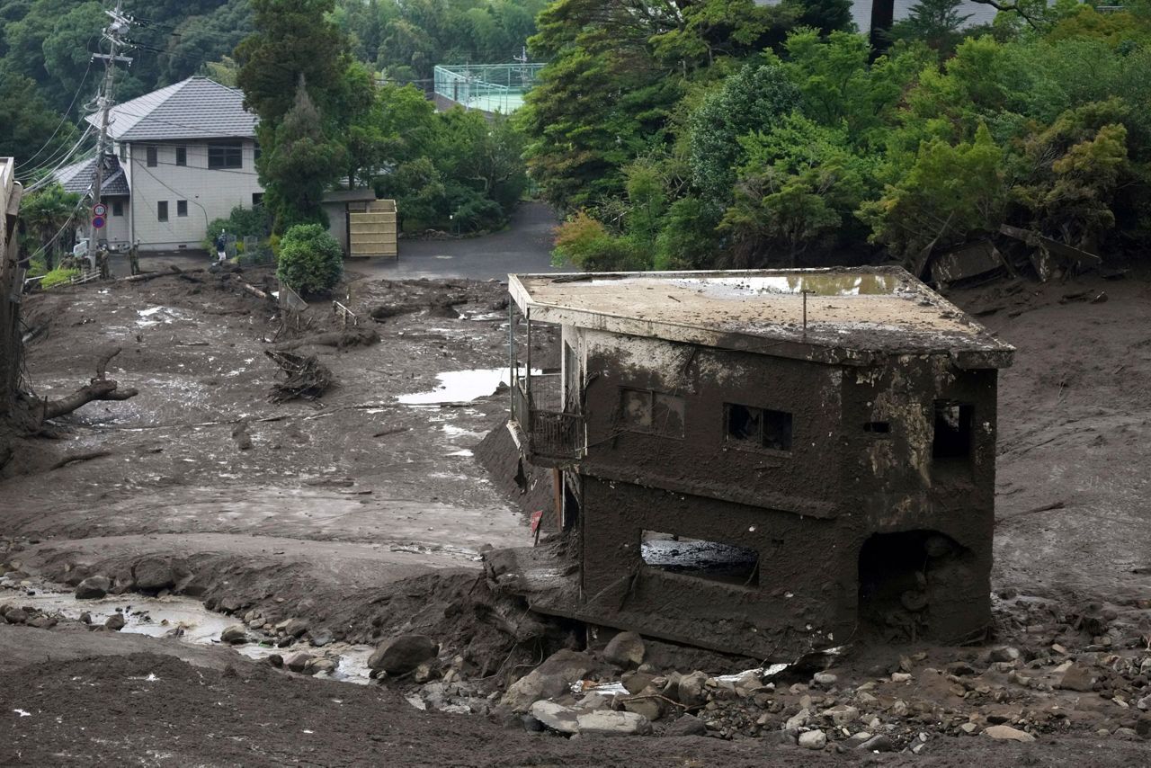 Rescuers slog through mud in Japan resort where 20 missing