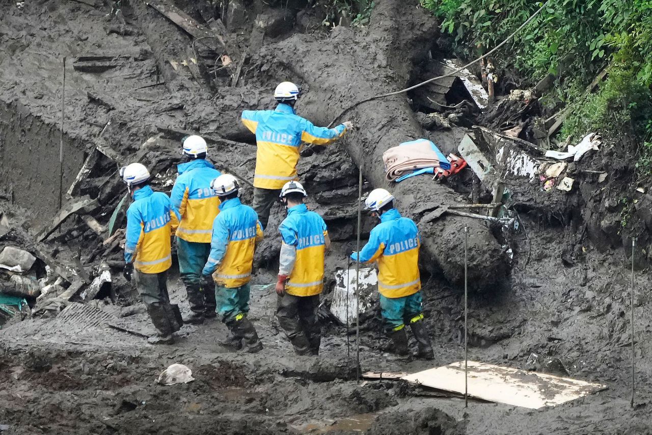 Rescuers slog through mud in Japan resort where 20 missing