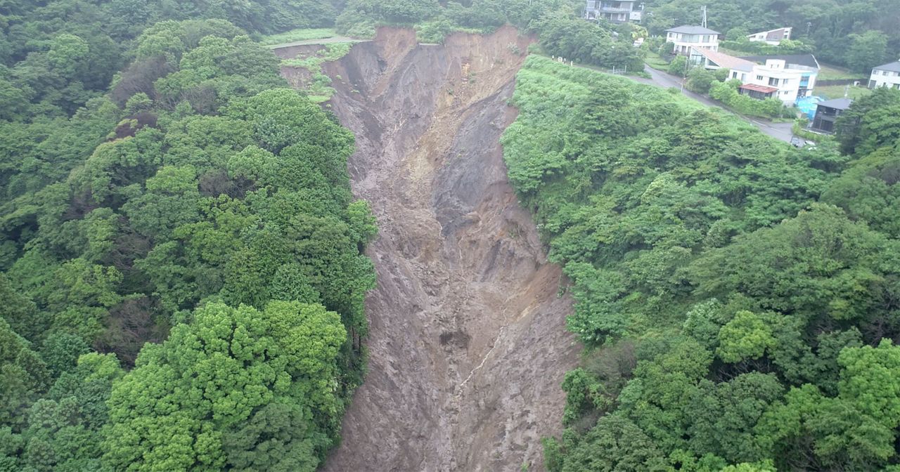 Rescuers slog through mud in Japan resort where 20 missing