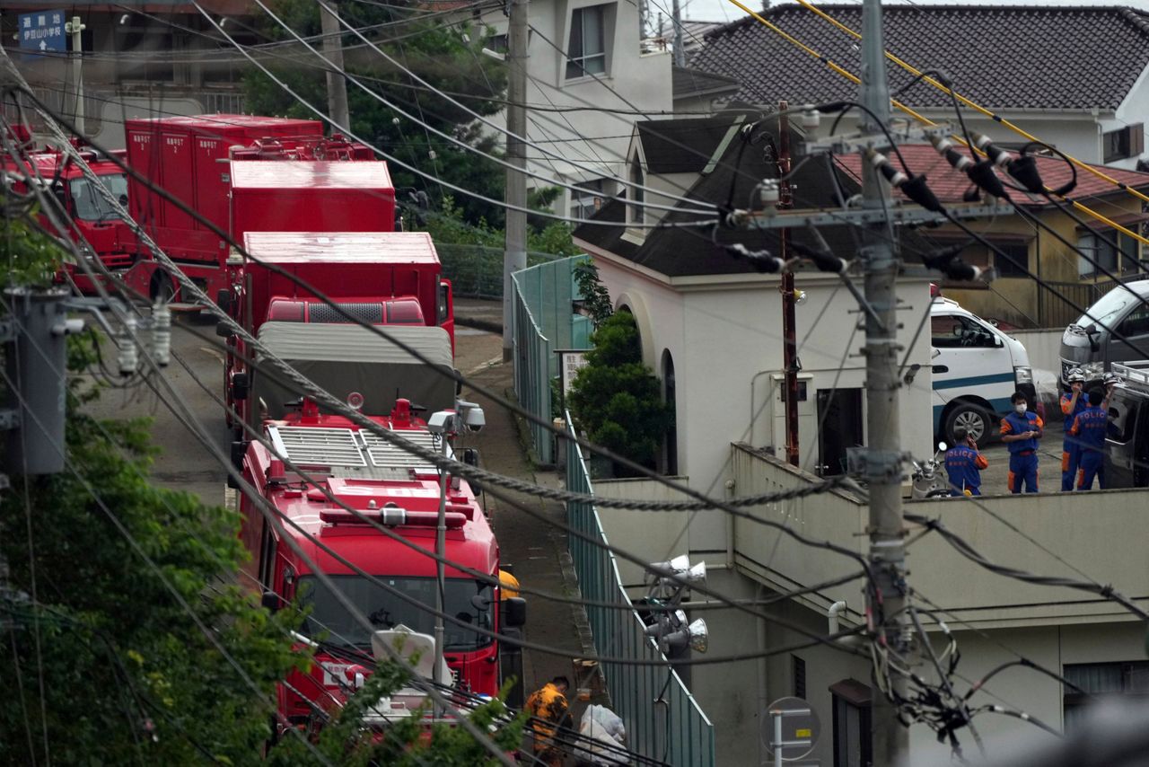 Rescuers slog through mud in Japan resort where 20 missing