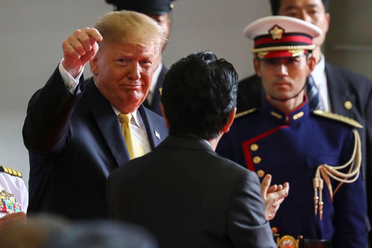 The Latest: Trump visits Japanese troops aboard destroyer