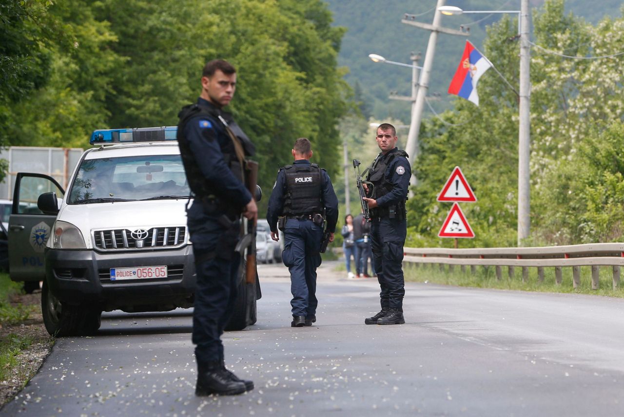 The Latest: 2 officers hurt as Kosovo police raid Serb areas