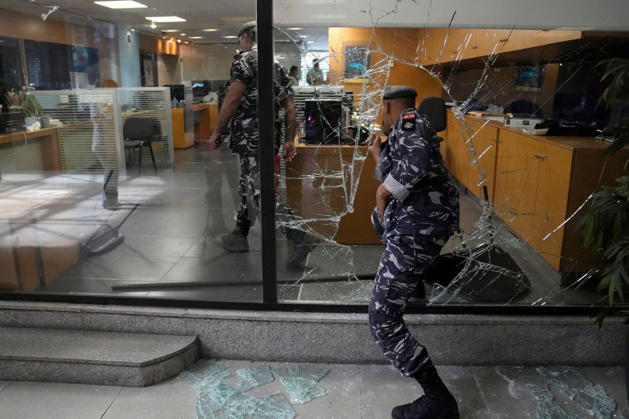 Armed woman breaks into Beirut bank, takes trapped savings